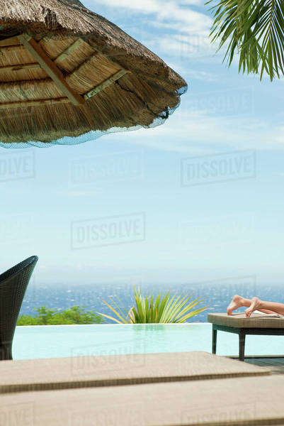 Person sunbathing at seaside resort - Stock Photo - Dissolve