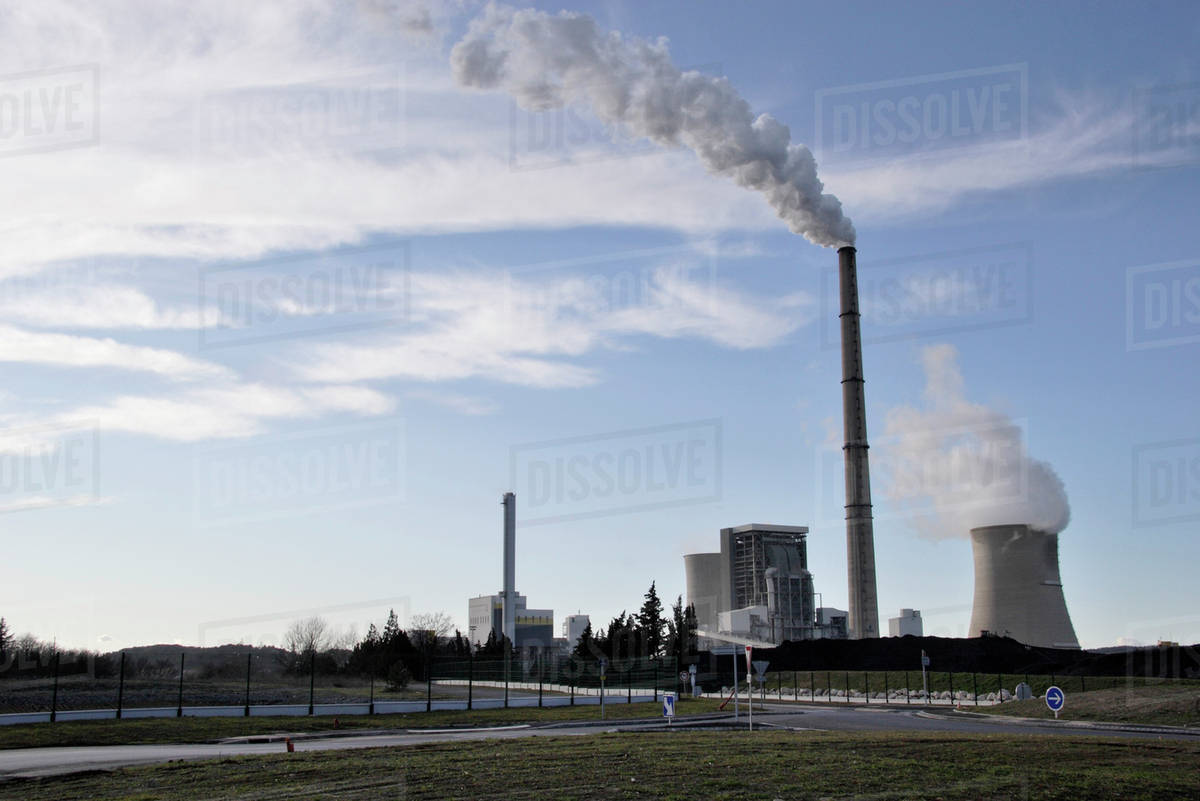 Factory, smoke coming out of smokestacks - Stock Photo - Dissolve
