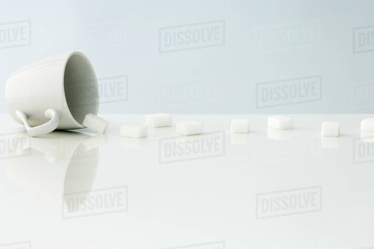 Sugar cubes spilling out of mug - Royalty-free Stock Photo | Dissolve