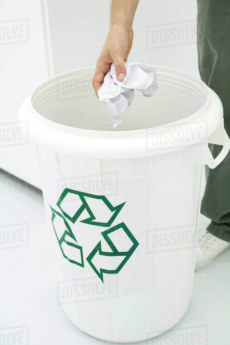 Man throwing crumpled paper in recycling bin, cropped view - Royalty ...