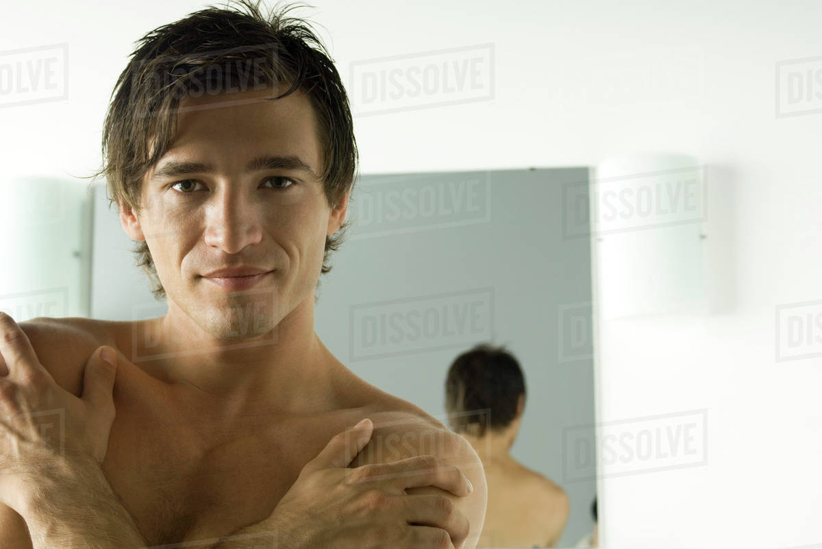 Man smiling at camera, arms folded across chest, portrait - Royalty ...