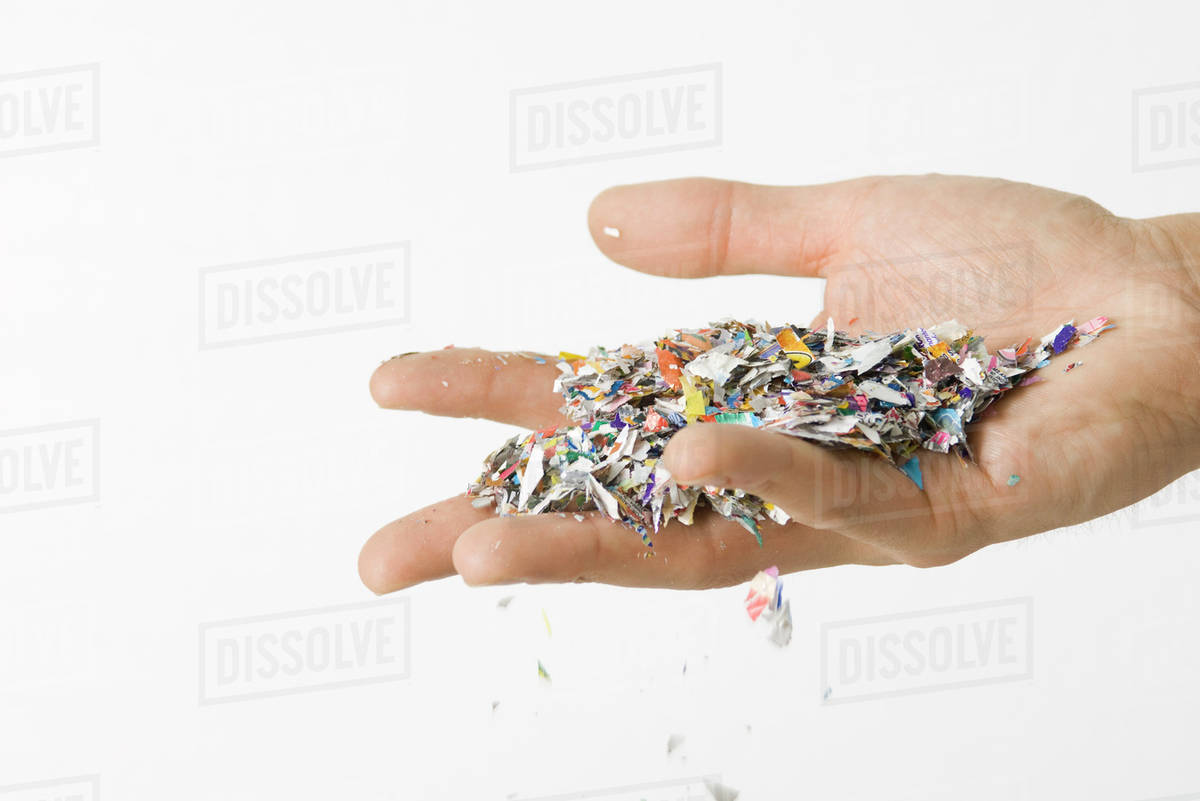 Hand holding confetti, cropped view - Royalty-free Stock Photo | Dissolve