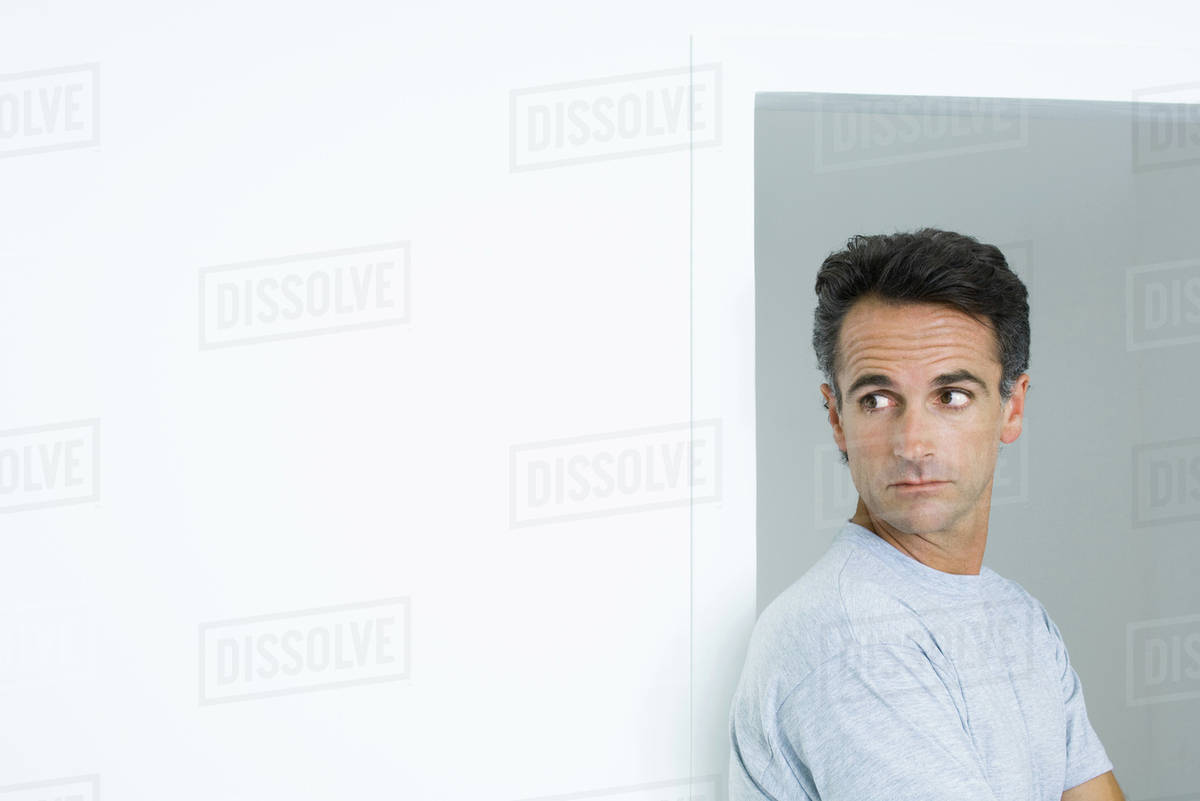 Man looking over shoulder, raising eyebrows - Royalty-free Stock Photo ...