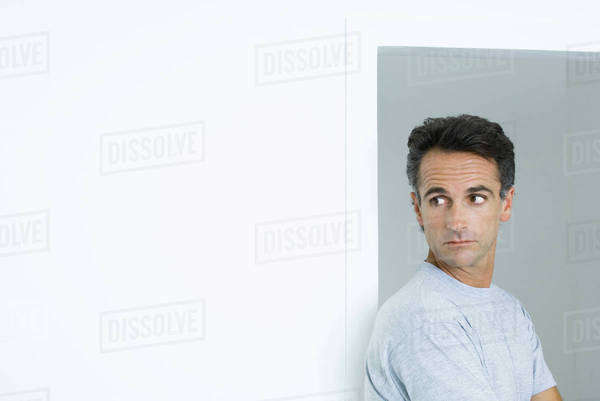 Man looking over shoulder, raising eyebrows - Royalty-free Stock Photo ...