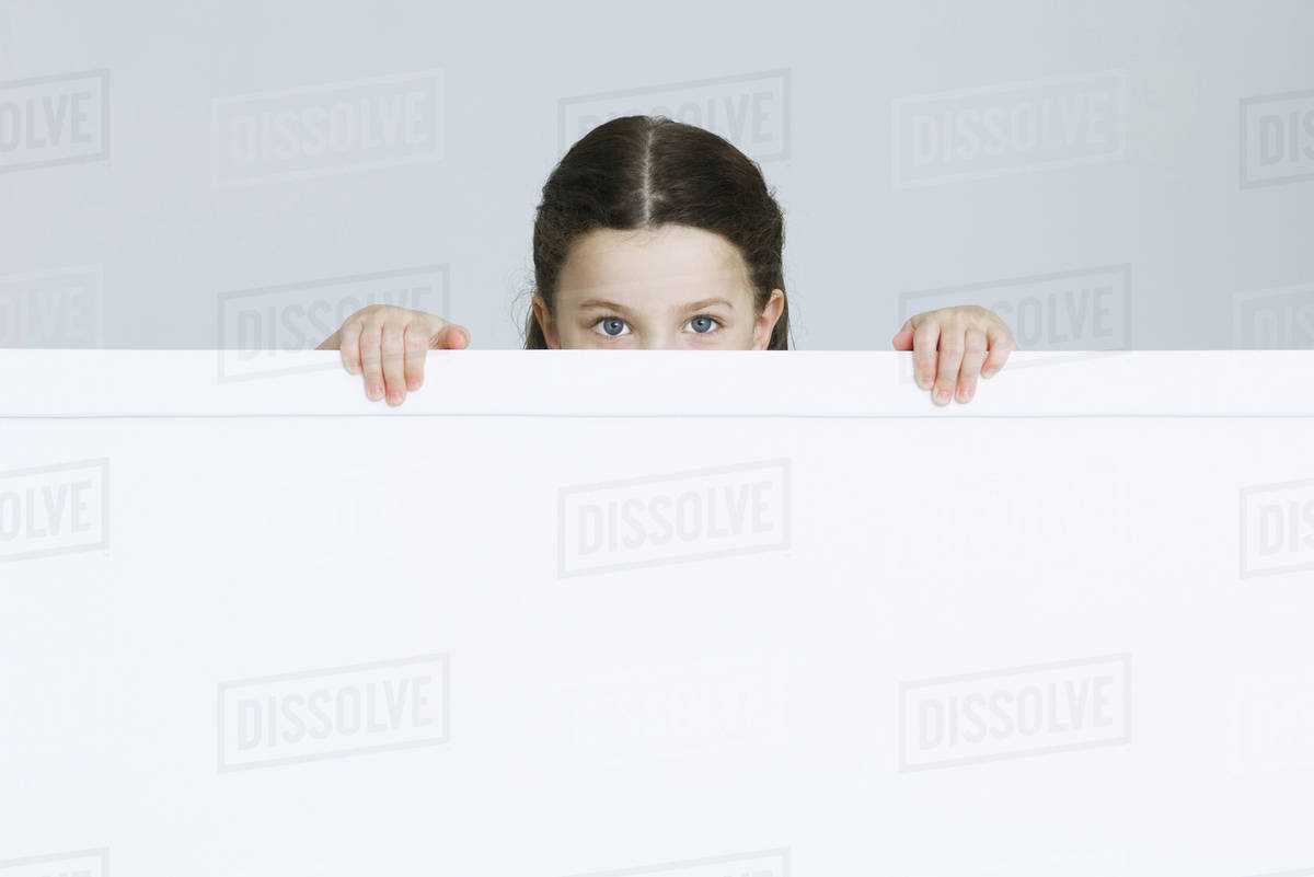 Little girl peeking over ledge at camera - Royalty-free Stock Photo ...