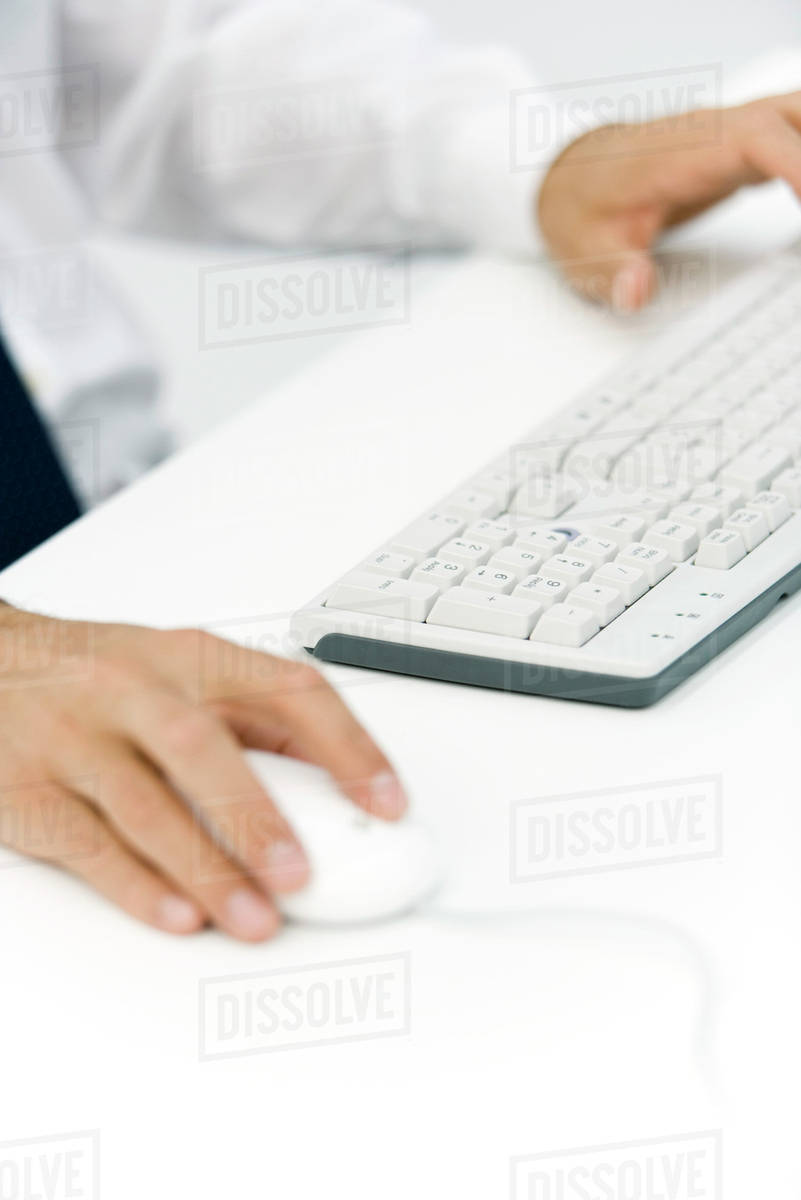 Businessman using keyboard and mouse, cropped view - Royalty-free Stock ...