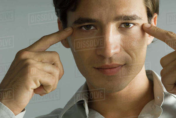 Man pointing at eyes, looking at camera, close-up - Royalty-free Stock ...