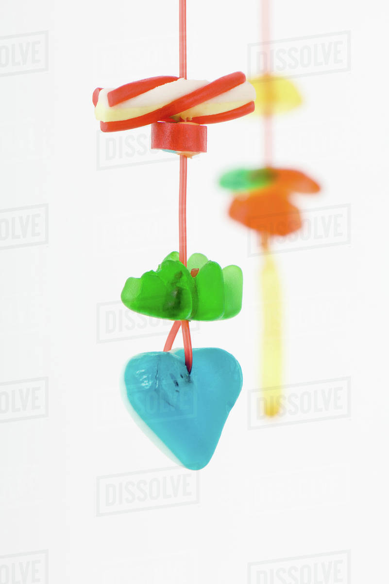 Colorful candy hanging on string - Royalty-free Stock Photo | Dissolve