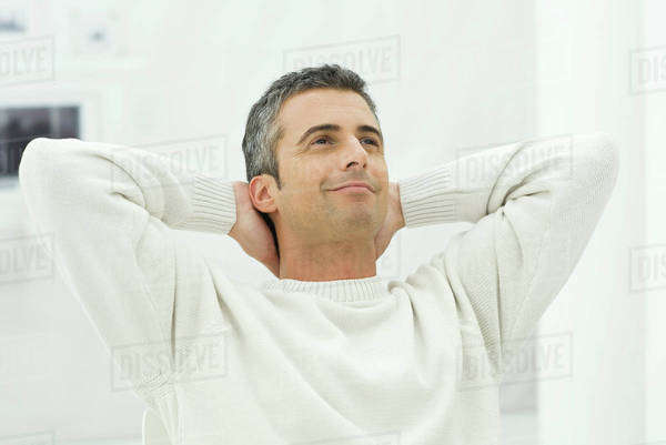 Man leaning back with hands behind head, smiling - Royalty-free Stock ...
