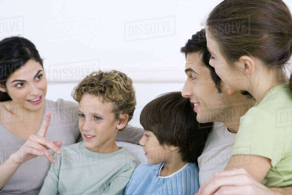 Family sitting together, having a discussion - Stock Photo - Dissolve