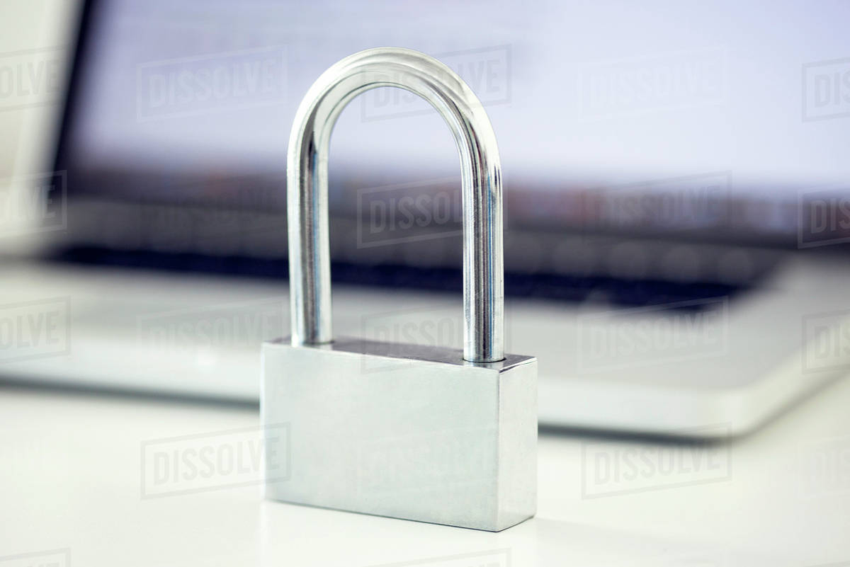 Padlock in front of laptop computer representing internet security ...