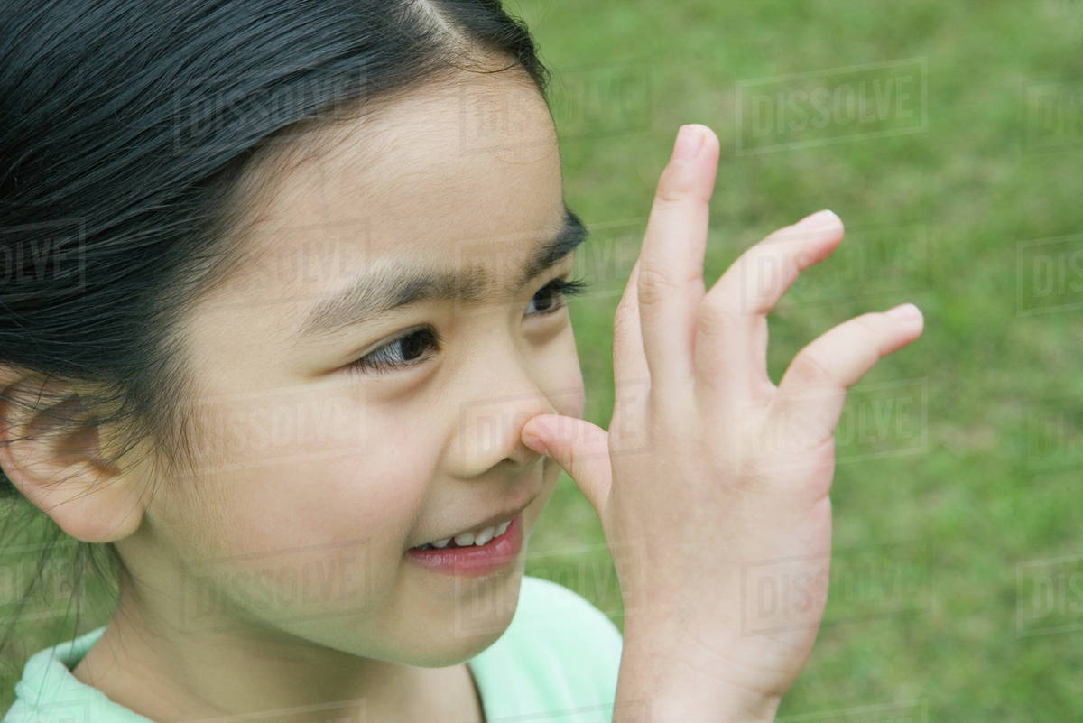 Little girl thumbing nose, close-up - Royalty-free Stock Photo | Dissolve