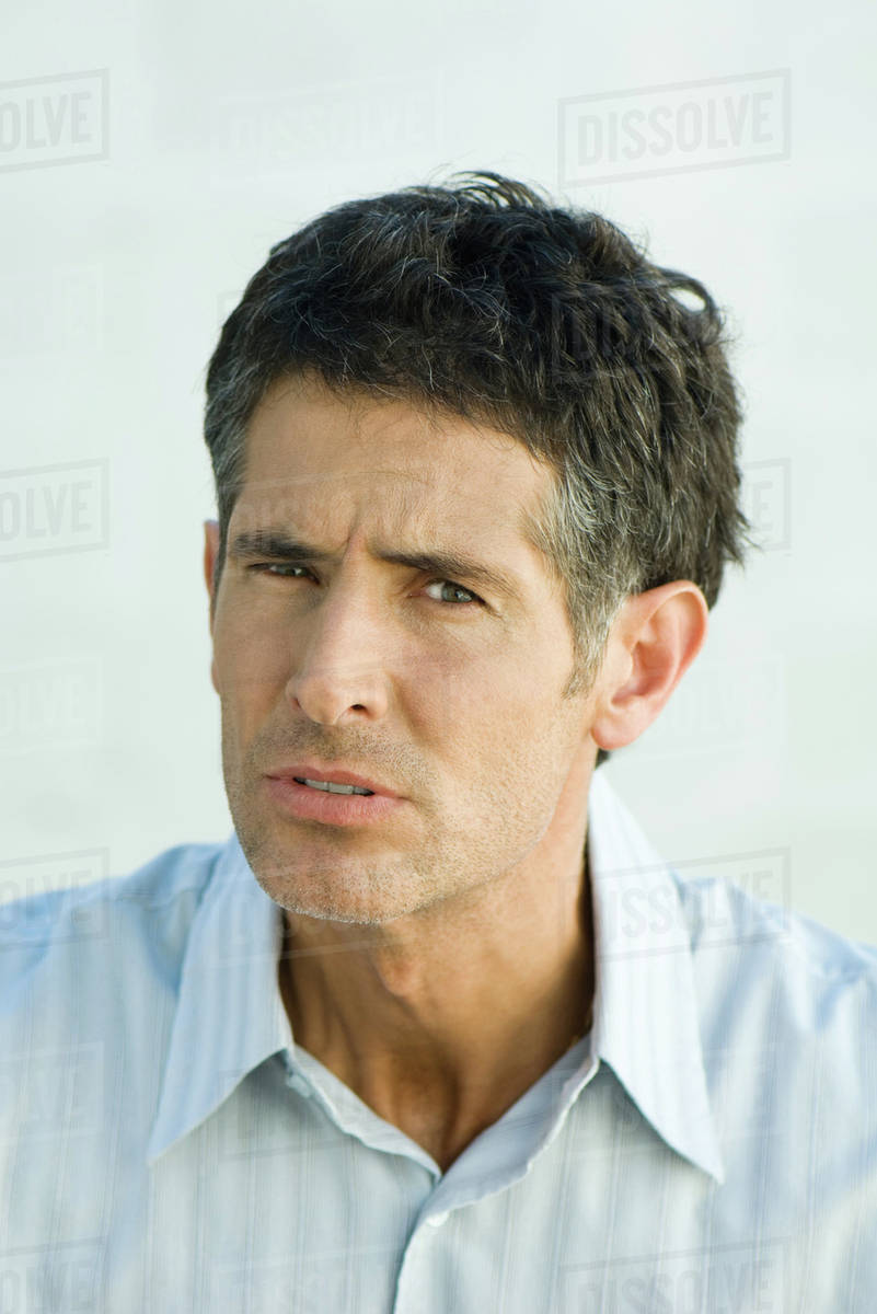 Man, furrowing brow, portrait - Royalty-free Stock Photo | Dissolve