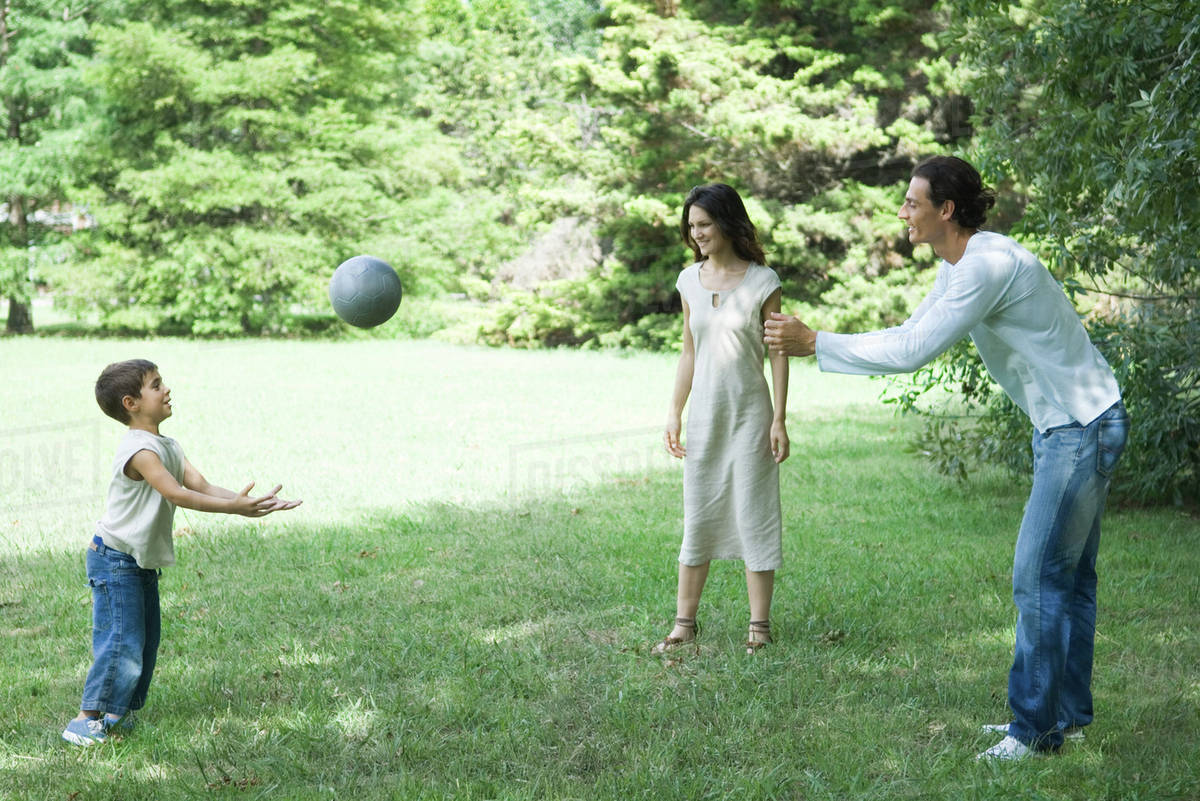 Family playing ball - Stock Photo - Dissolve
