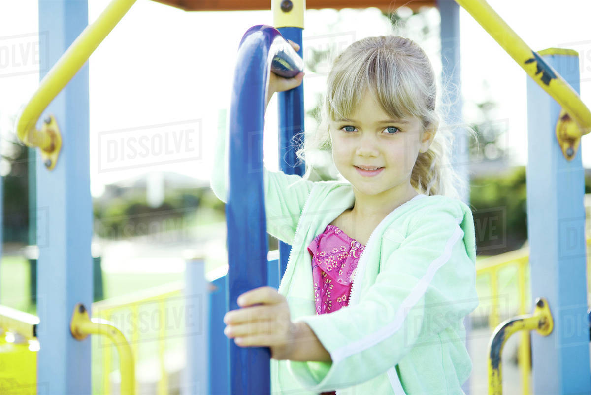 Child on playground equipment - Stock Photo - Dissolve