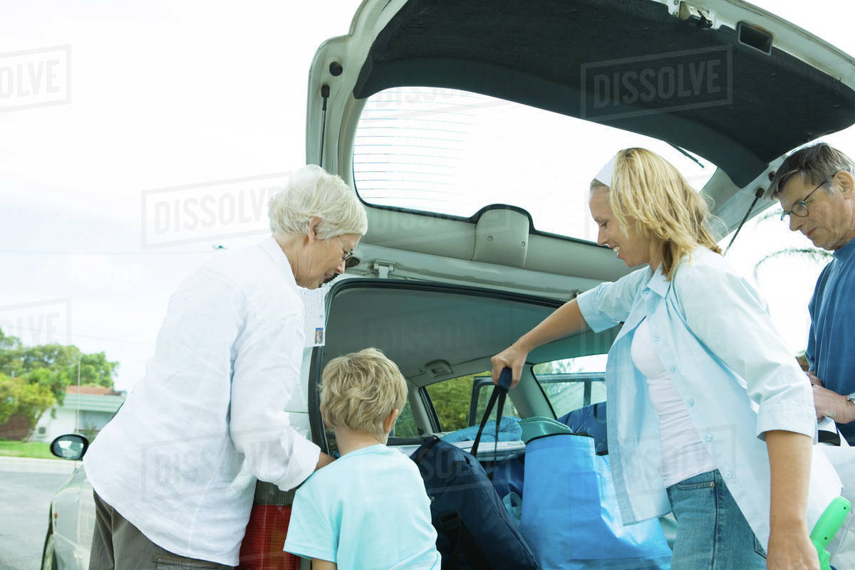 Family unloading trunk of car - Royalty-free Stock Photo | Dissolve