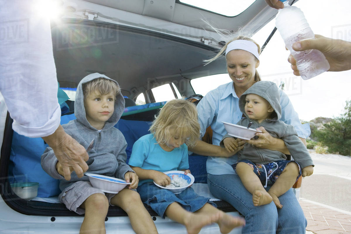 Children eating meal in back of car - Royalty-free Stock Photo | Dissolve