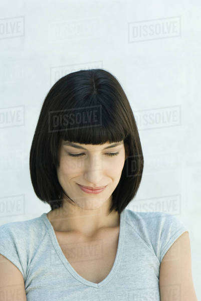 Young woman smirking, portrait - Stock Photo - Dissolve