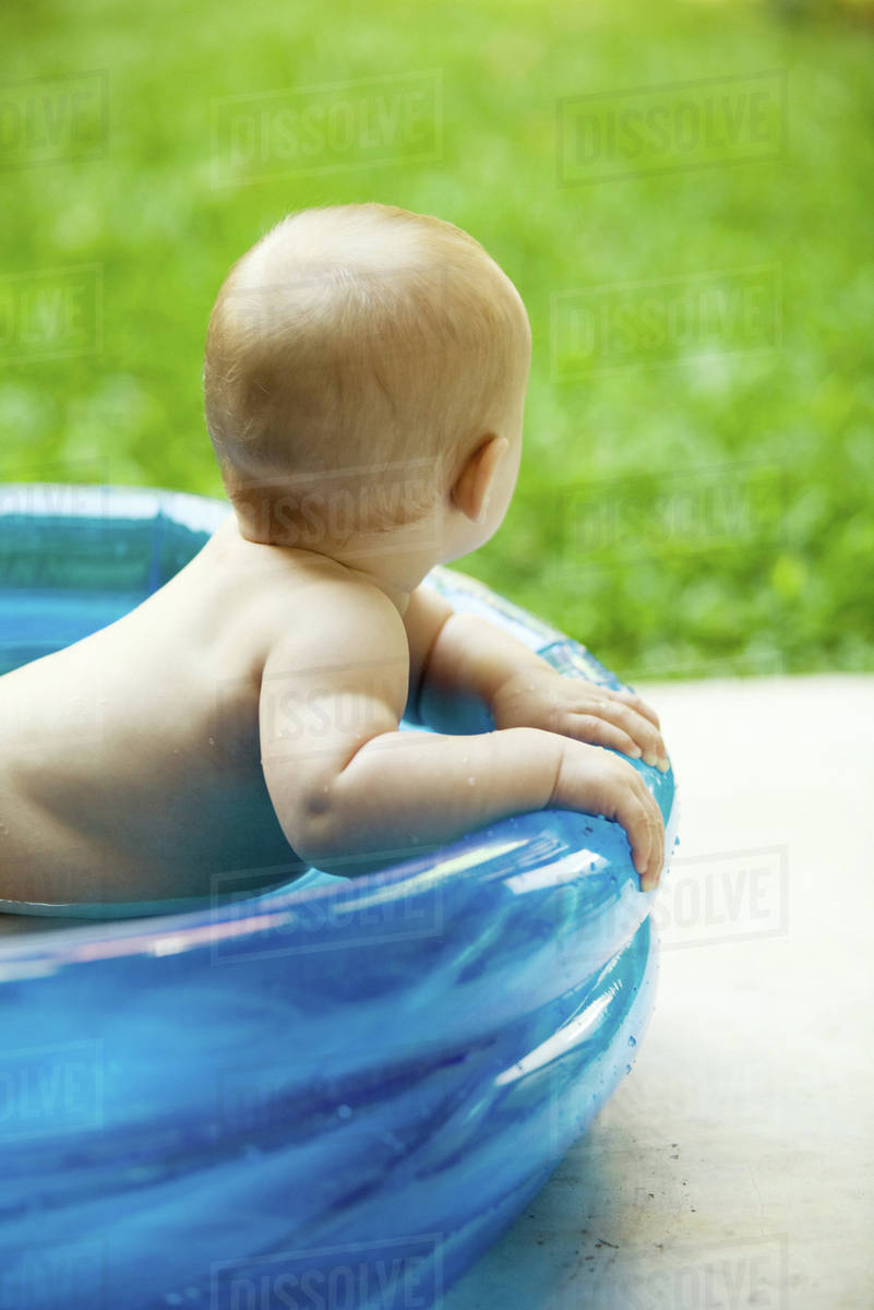 Baby in inflatable baby pool, head turned away - Royalty-free Stock ...