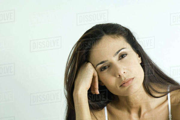 Woman leaning on hand, looking at camera, portrait - Stock Photo - Dissolve