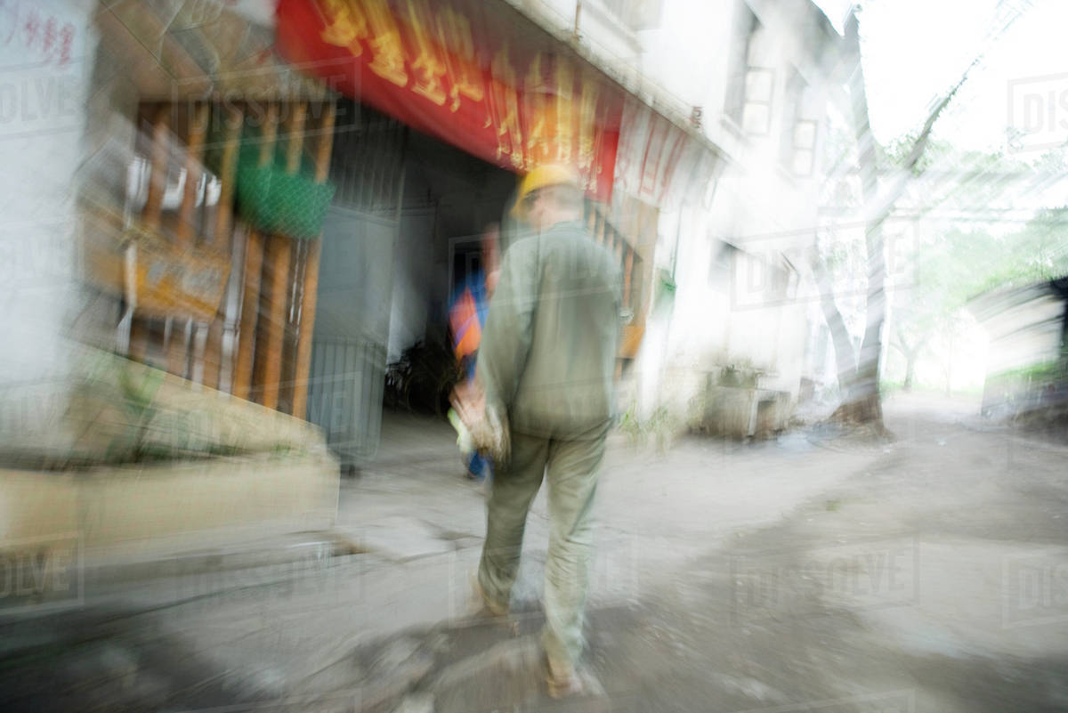 Construction worker walking away, blurred motion - Royalty-free Stock ...
