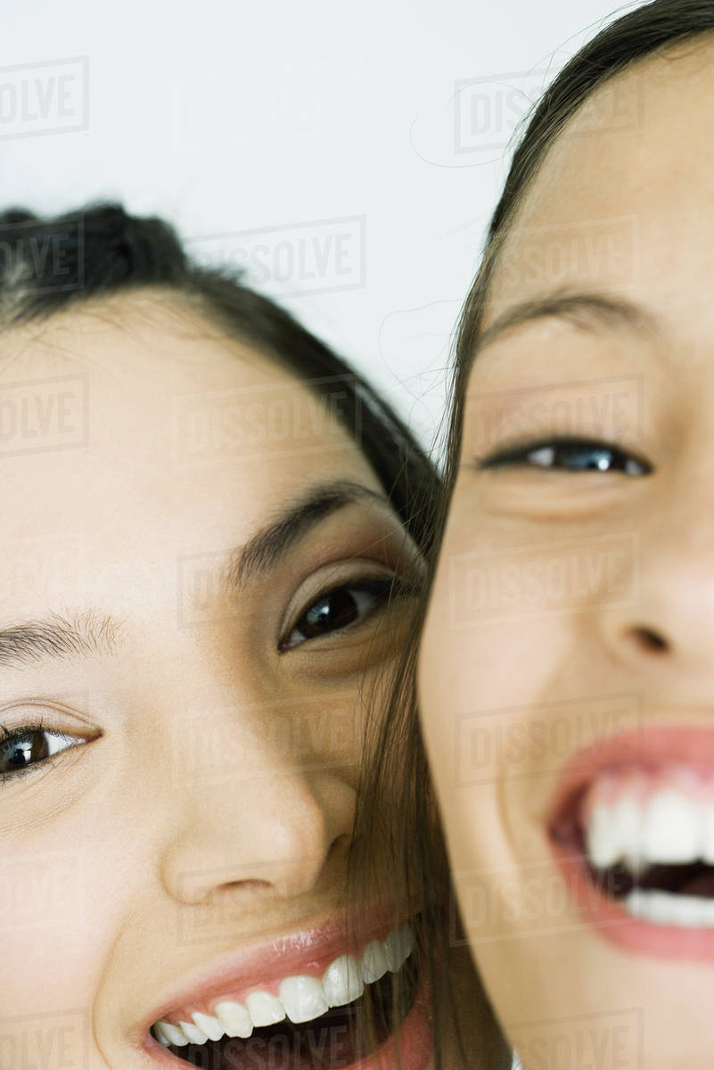 Two young friends smiling at camera, cropped view, close-up - Royalty ...