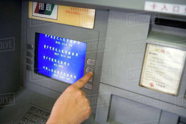 Person using ATM in China, cropped view - Stock Photo - Dissolve