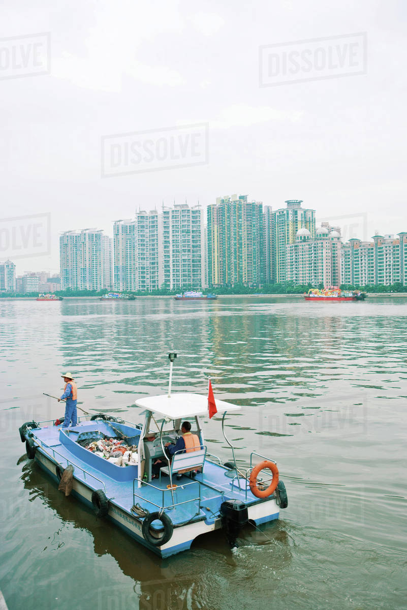 Garbage boat cleaning river - Stock Photo - Dissolve