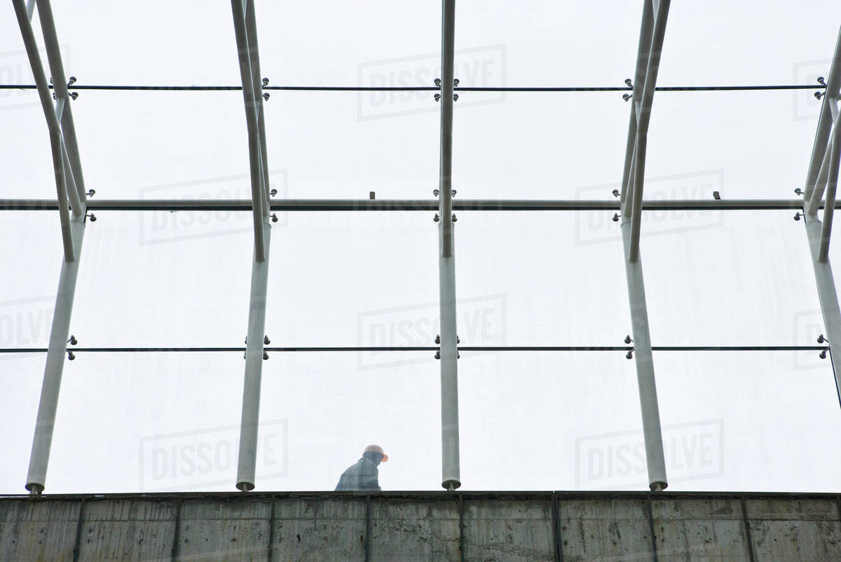 Construction worker seen through framework - Royalty-free Stock Photo ...