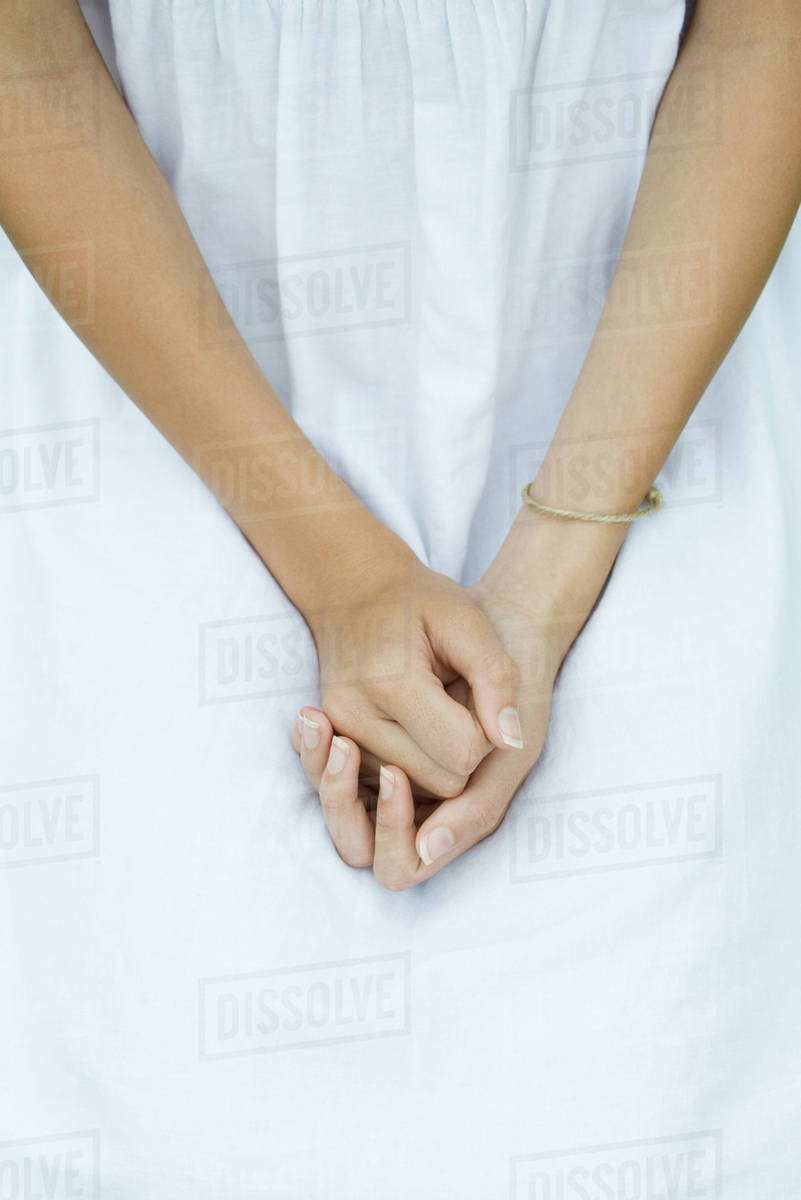 Teenage girl with clasped hands, cropped view - Royalty-free Stock ...