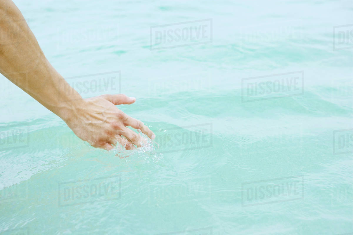 Hand touching water, close-up - Royalty-free Stock Photo | Dissolve