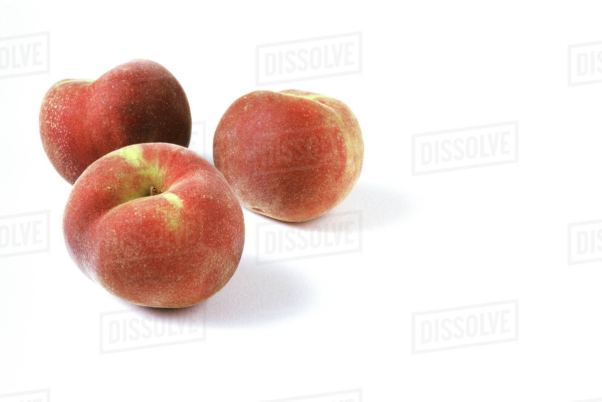 Three peaches, close-up - Royalty-free Stock Photo | Dissolve