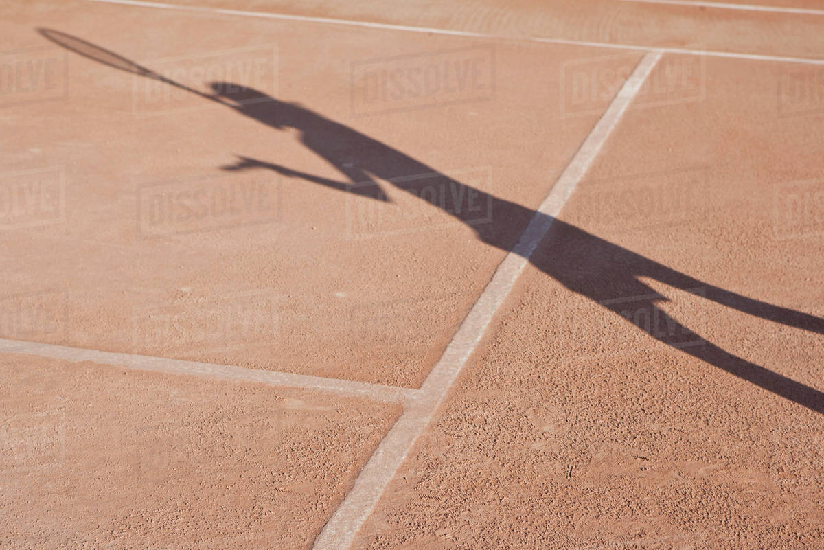 Shadow of person playing tennis - Royalty-free Stock Photo | Dissolve