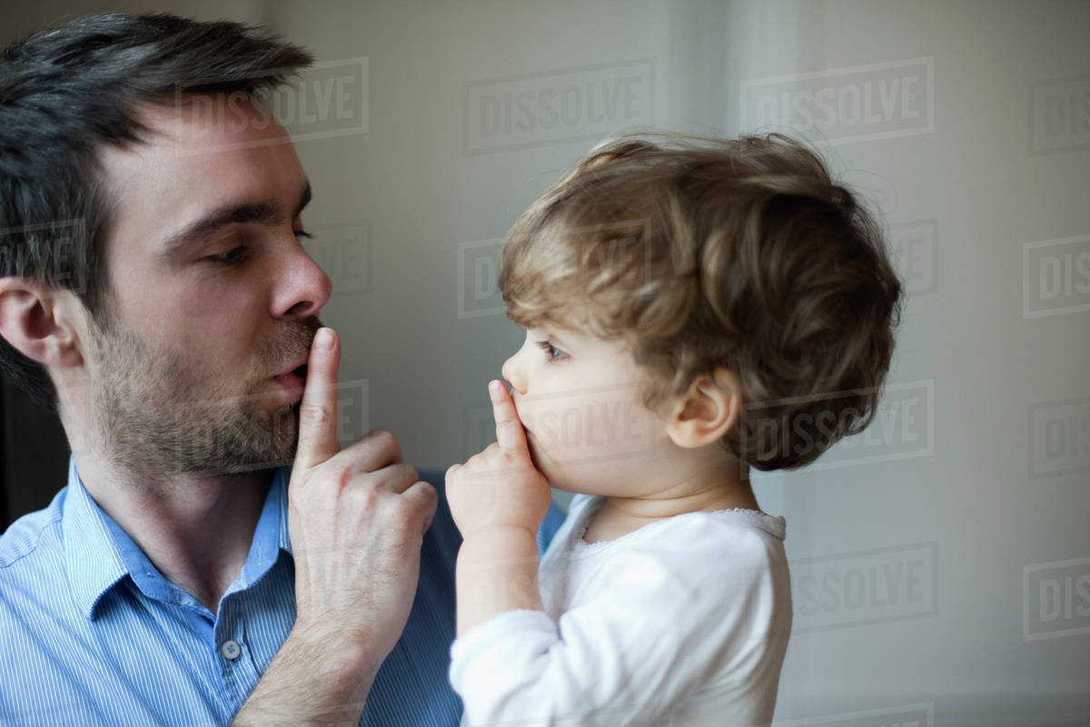 Father teaching toddler son to hush - Royalty-free Stock Photo | Dissolve