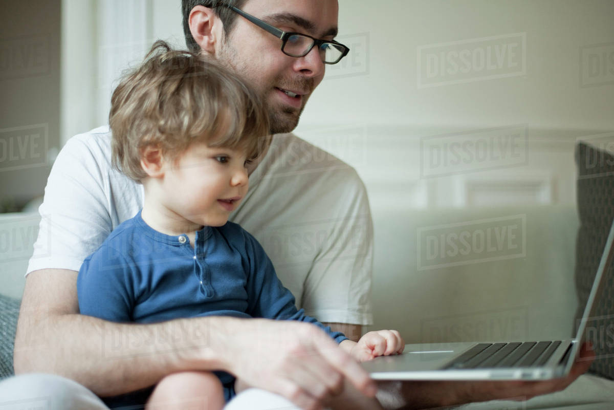 Toddler boy using laptop computer with father - Royalty-free Stock ...