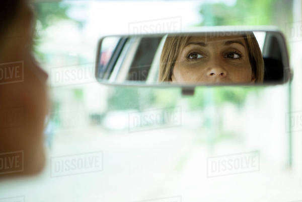 Driver checking rear view mirror - Royalty-free Stock Photo | Dissolve