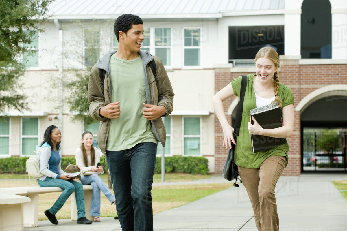 High school friends walking together on campus - Stock Photo - Dissolve