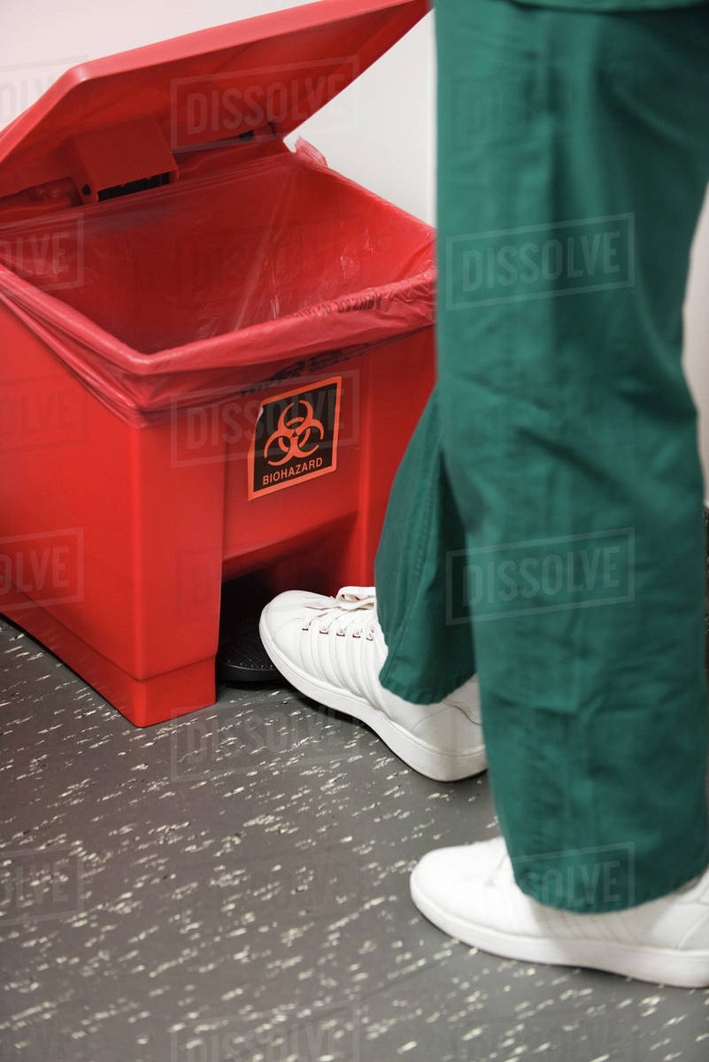 Throwing away medical waste in biohazard garbage can - Royalty-free ...