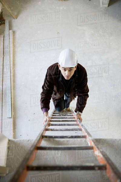 Construction worker climbing ladder - Royalty-free Stock Photo | Dissolve