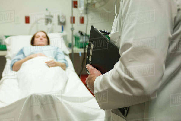 Doctor monitoring patient in hospital - Royalty-free Stock Photo | Dissolve