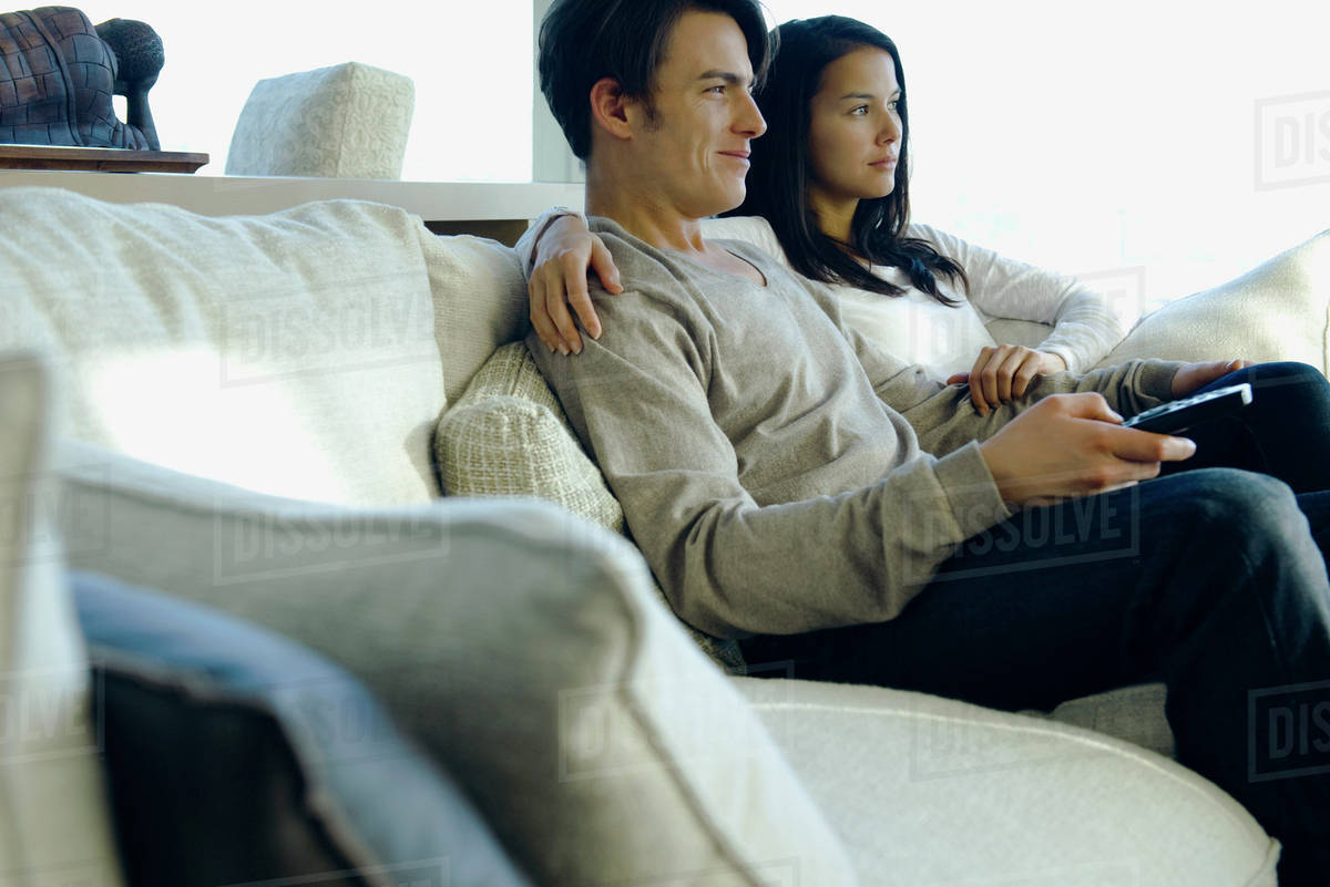 Couple watching TV together - Stock Photo - Dissolve