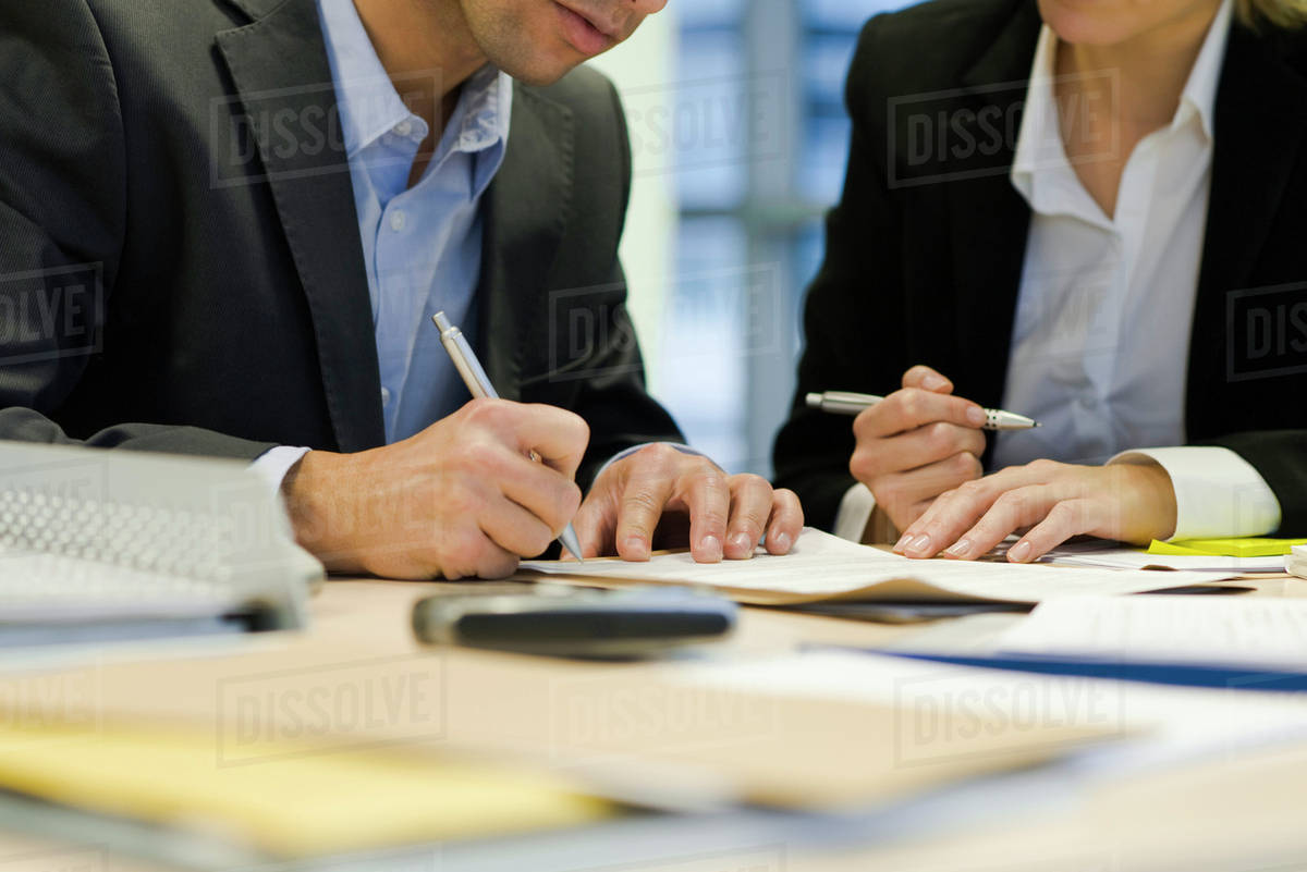 Executive signing paperwork, cropped - Royalty-free Stock Photo | Dissolve