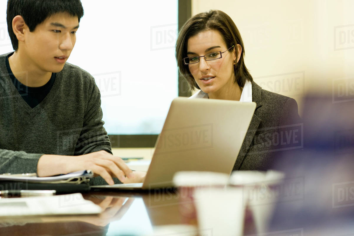 Colleagues working together on laptop computer - Royalty-free Stock ...
