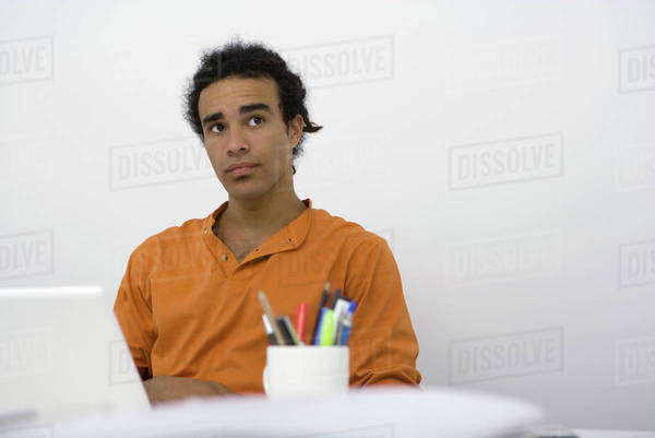 Man sitting at desk, looking up in thought - Royalty-free Stock Photo ...