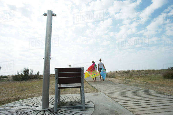Teen girls walking on boardwalk, carrying floats - Royalty-free Stock ...
