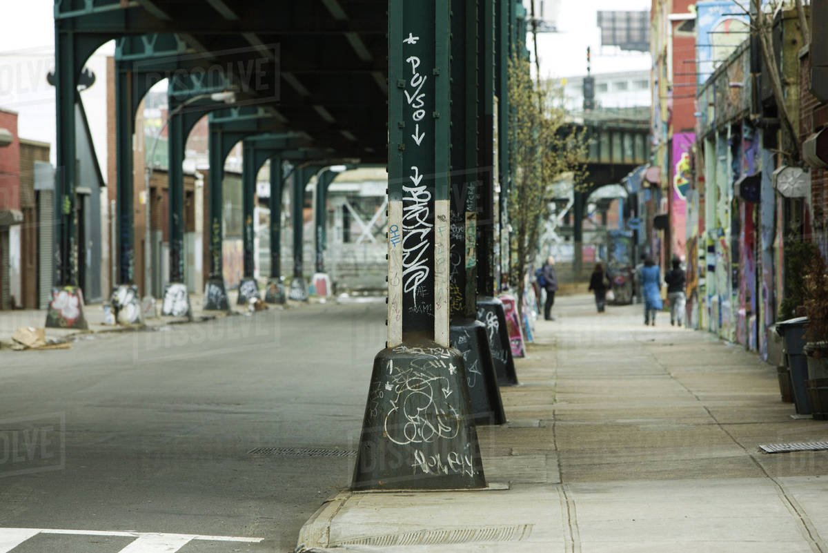 Graffiti on support column of elevated road - Stock Photo - Dissolve