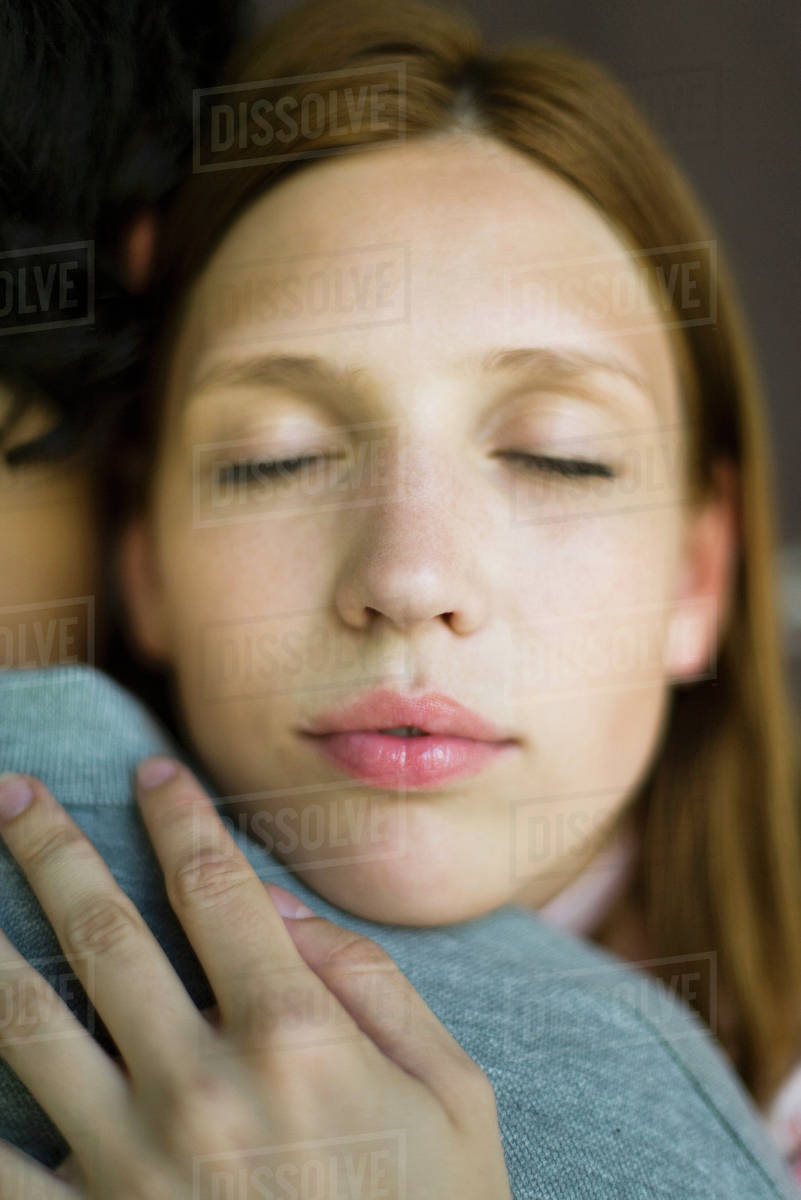 Young woman embracing man, eyes closed, close-up - Royalty-free Stock ...