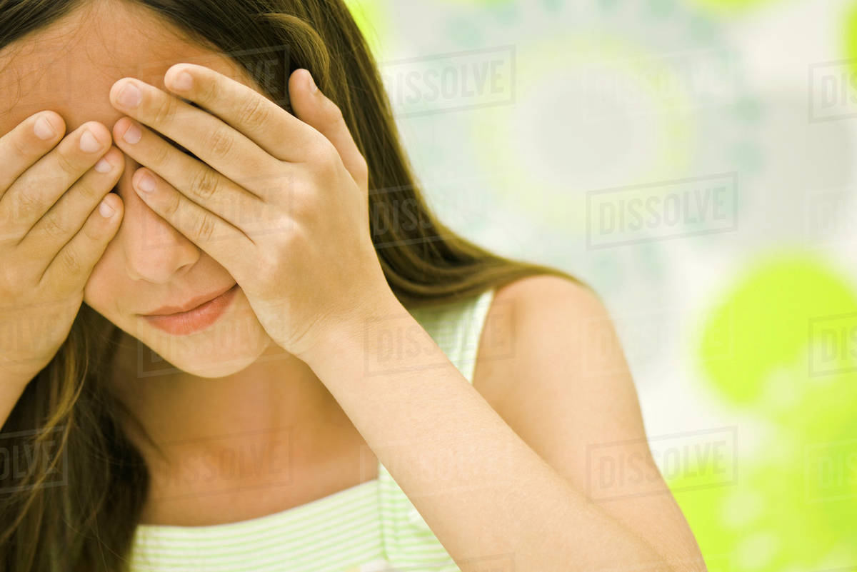Girl covering eyes with hands - Royalty-free Stock Photo | Dissolve