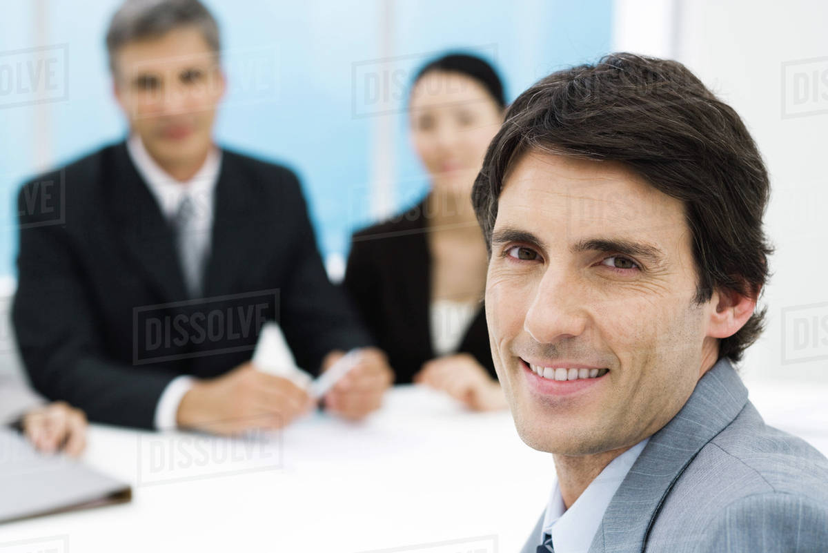 Businessman in meeting, smiling at camera - Royalty-free Stock Photo ...