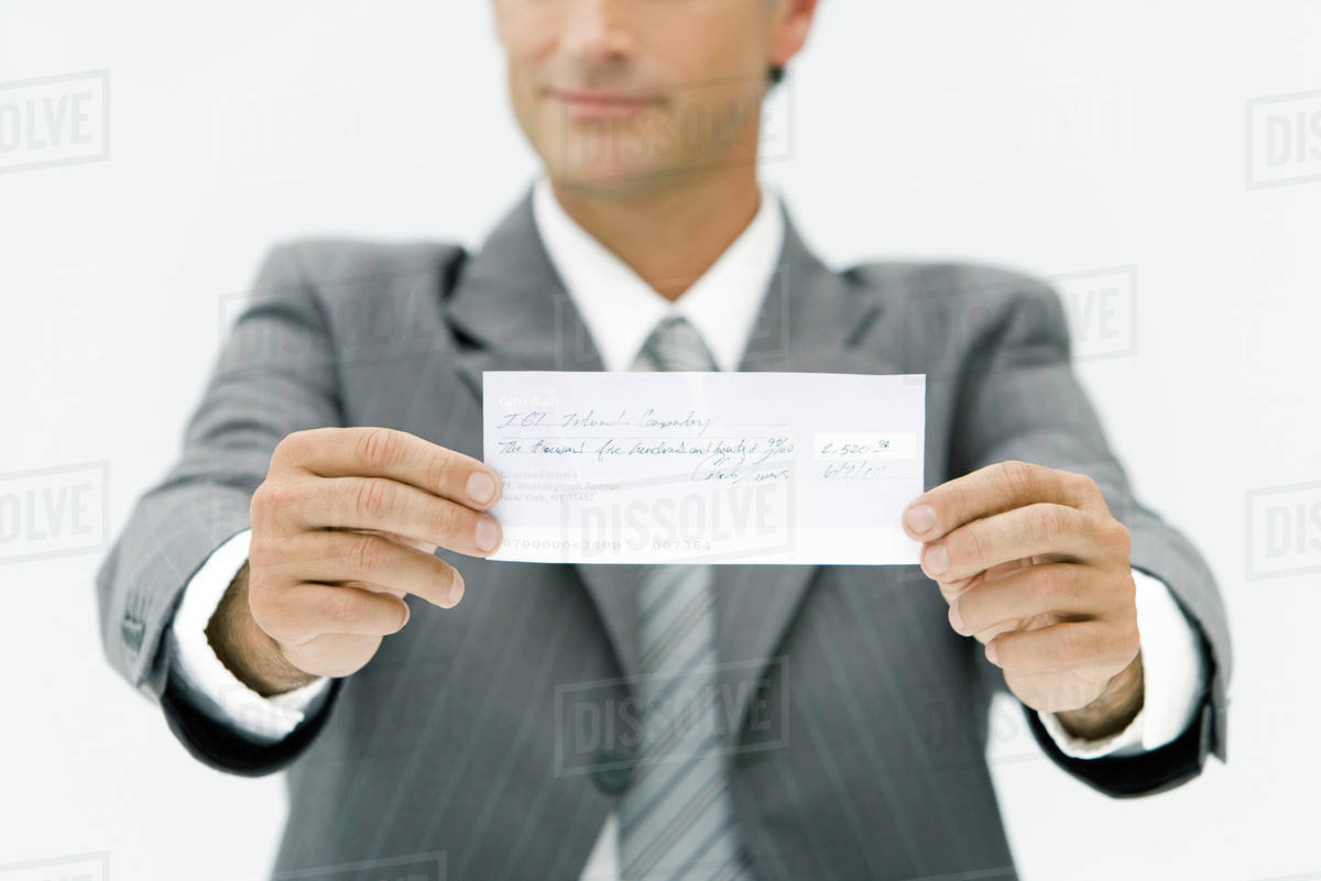 Businessman holding out check, cropped view - Royalty-free Stock Photo ...